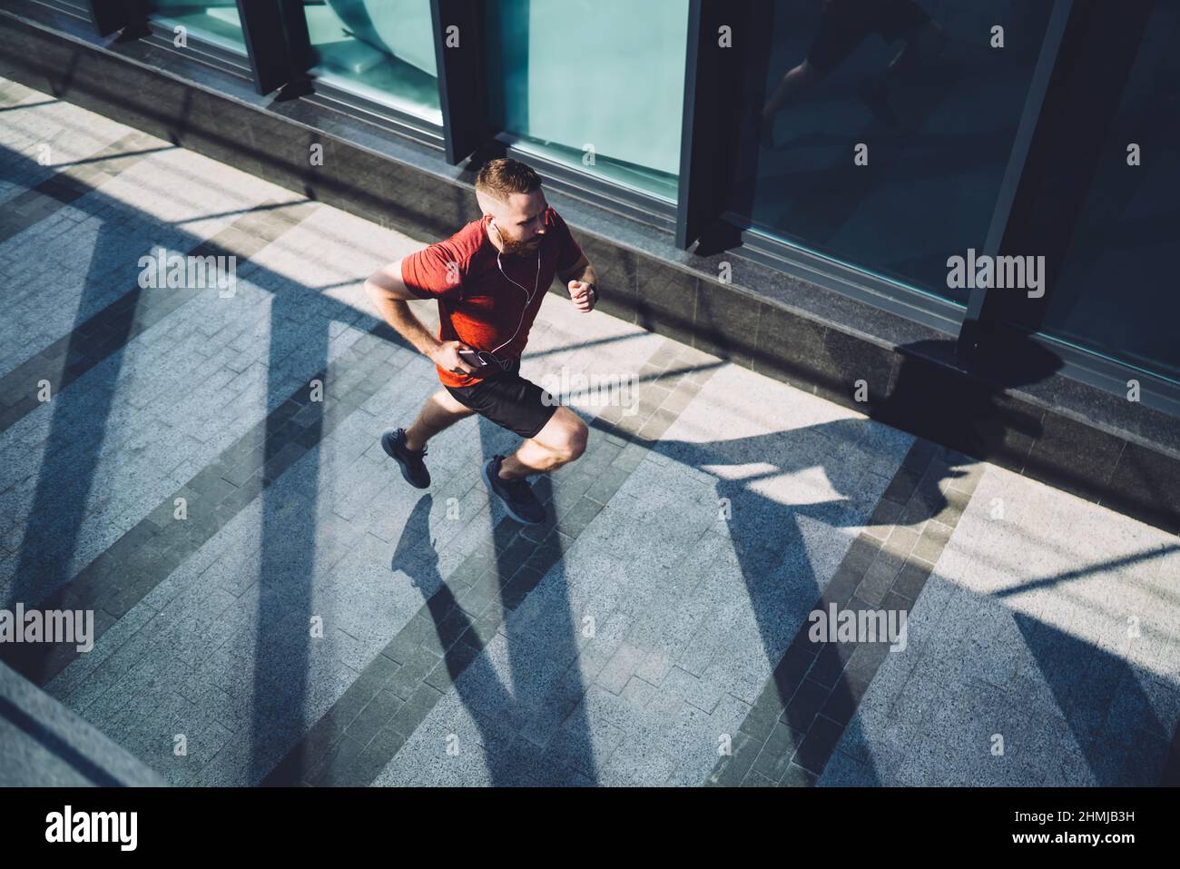 Male runner earphones hi-res stock photography and images - Alamy