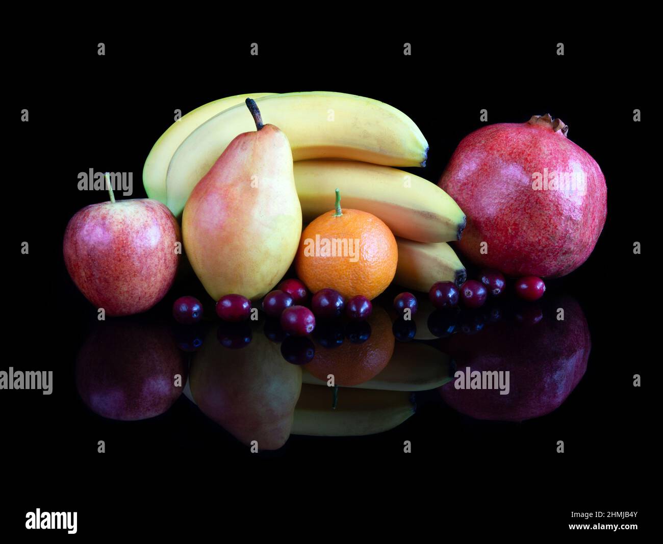 Fruits on reflective black studio background Stock Photo - Alamy
