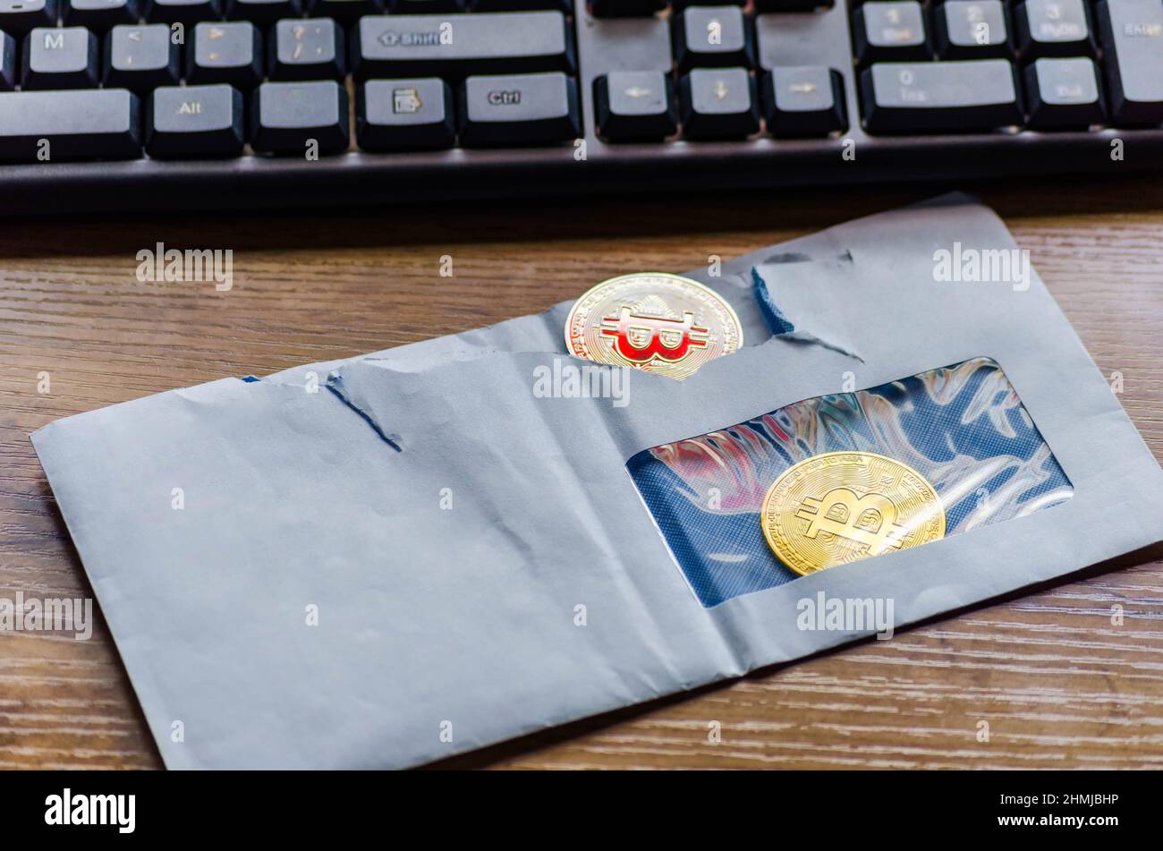Bitcoin in a paper envelope on the desktop with a keyboard Stock Photo ...