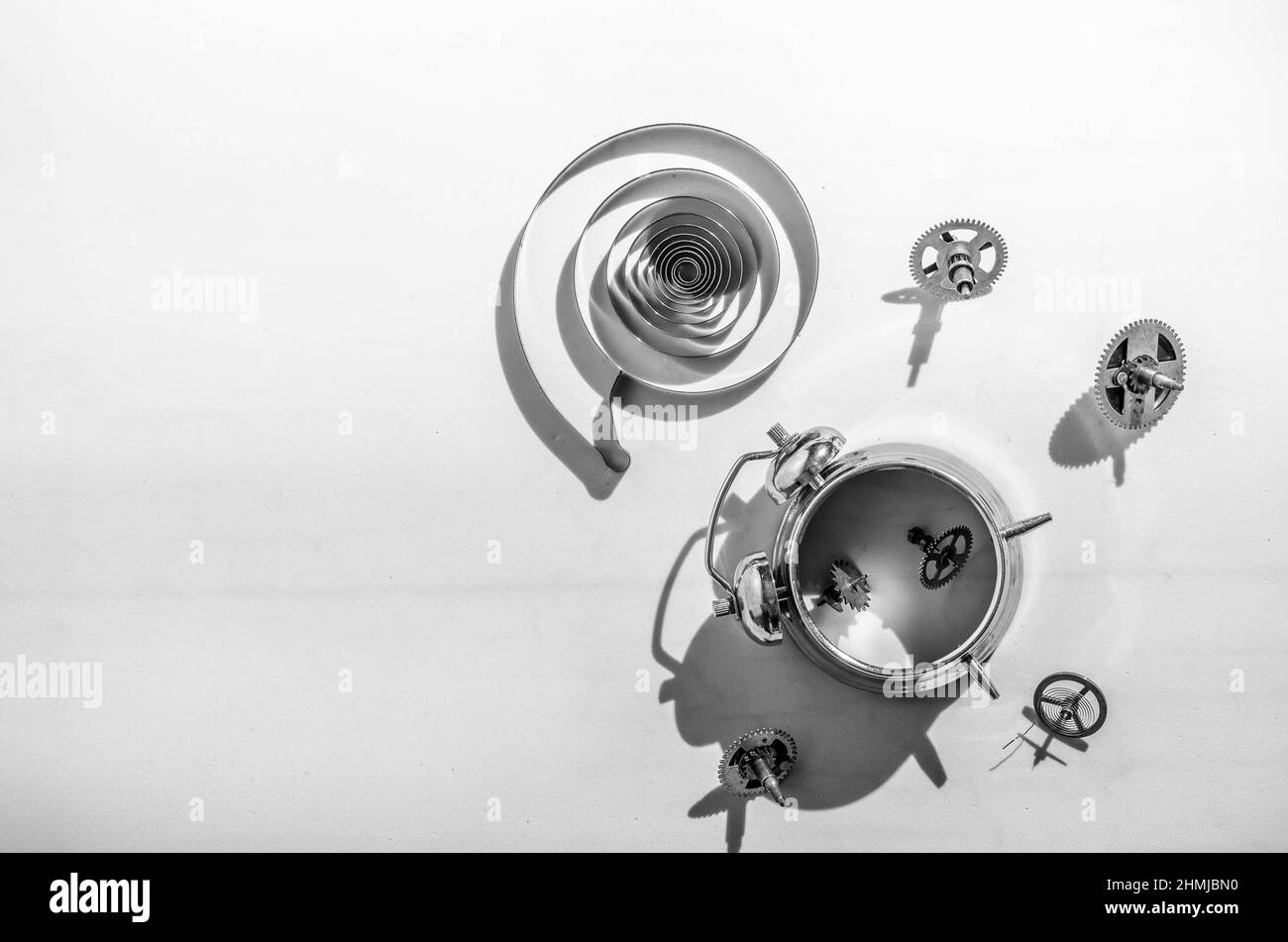 Disassembled alarm clock with scattered gears with a view from the top ...