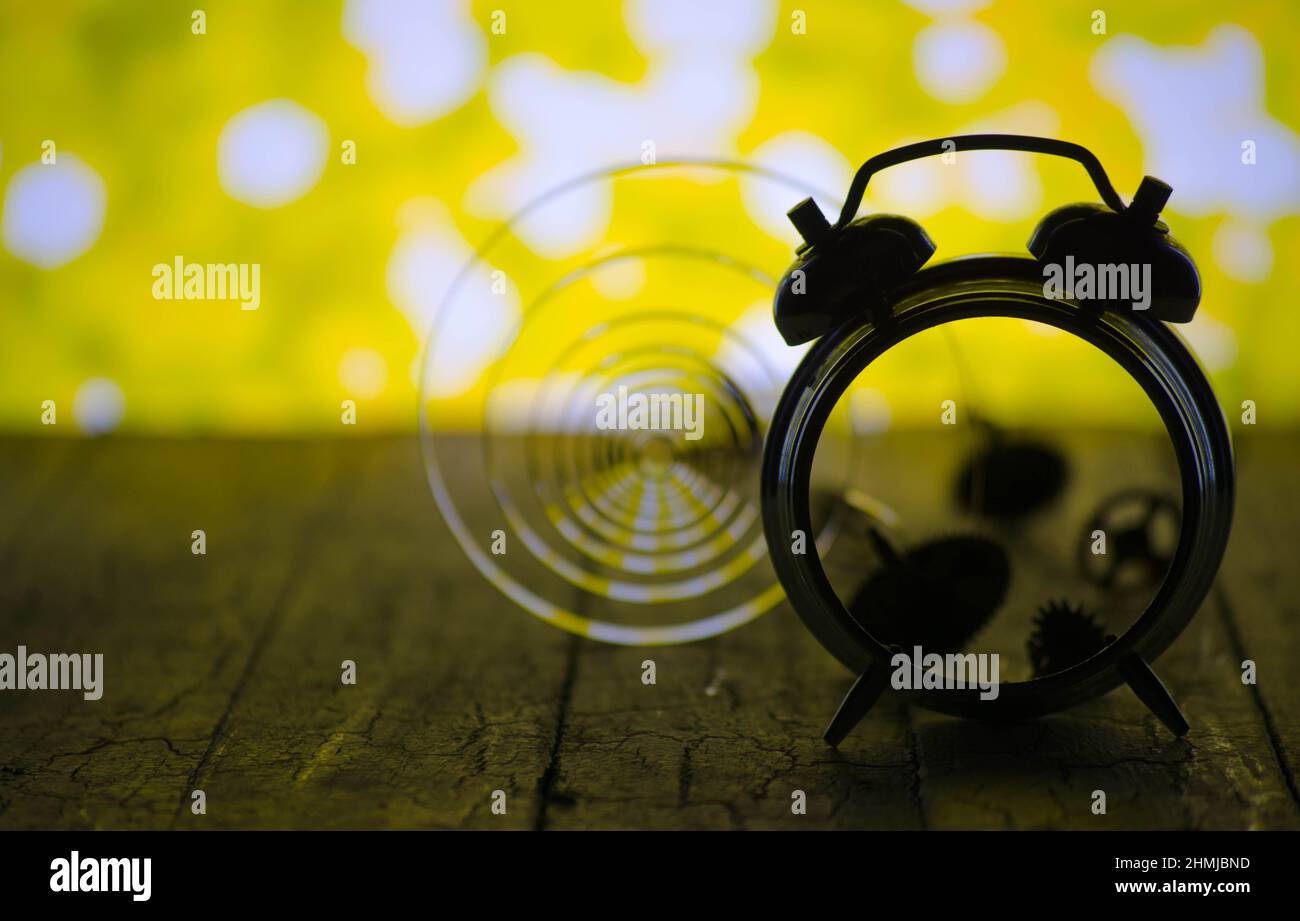 Broken alarm clock with springs and gears scattered on the background ...
