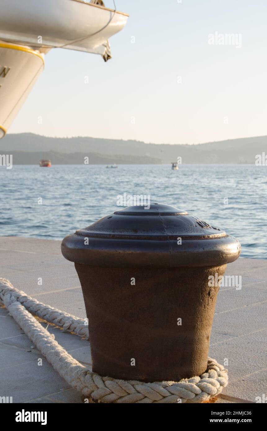 Large metal bollard in the port for mooring ships, yachts and sailing ...