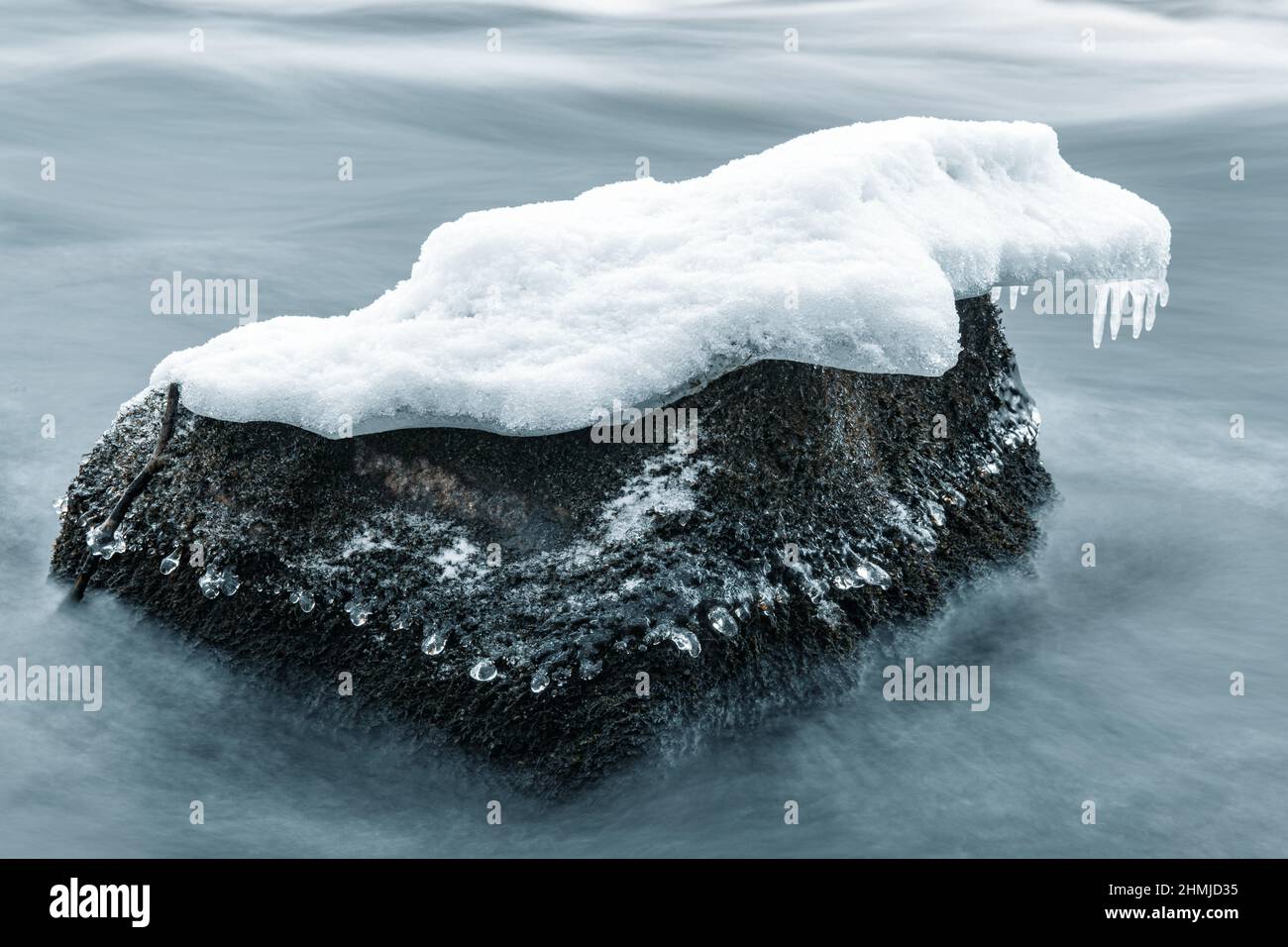 Ice on stone in winter river Stock Photo - Alamy