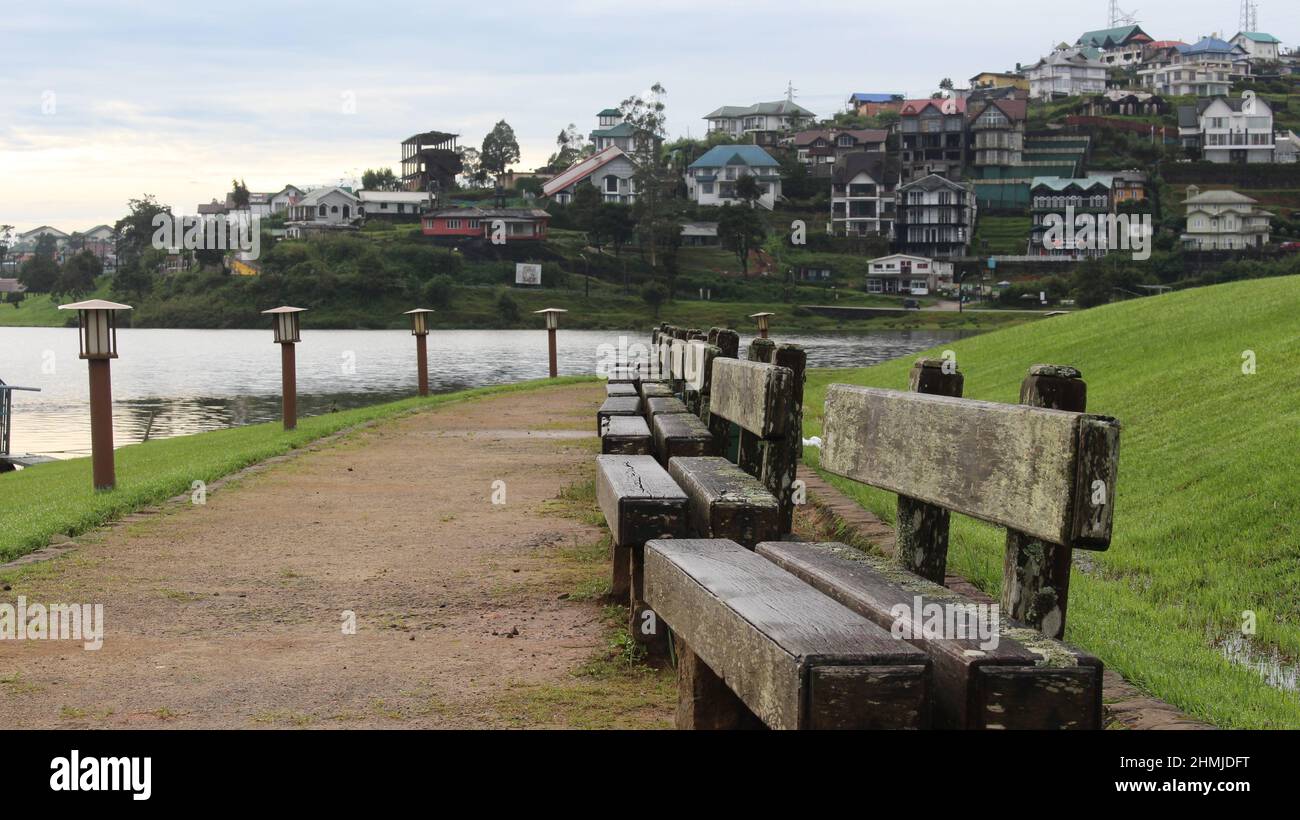 Wooden benches by a river Stock Photo - Alamy