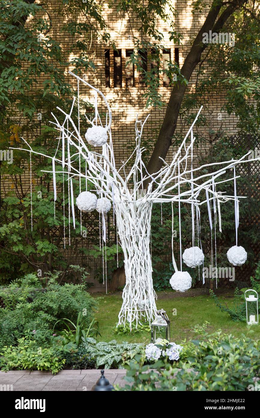 White painted tree with hanging balls, installation in the park Stock ...