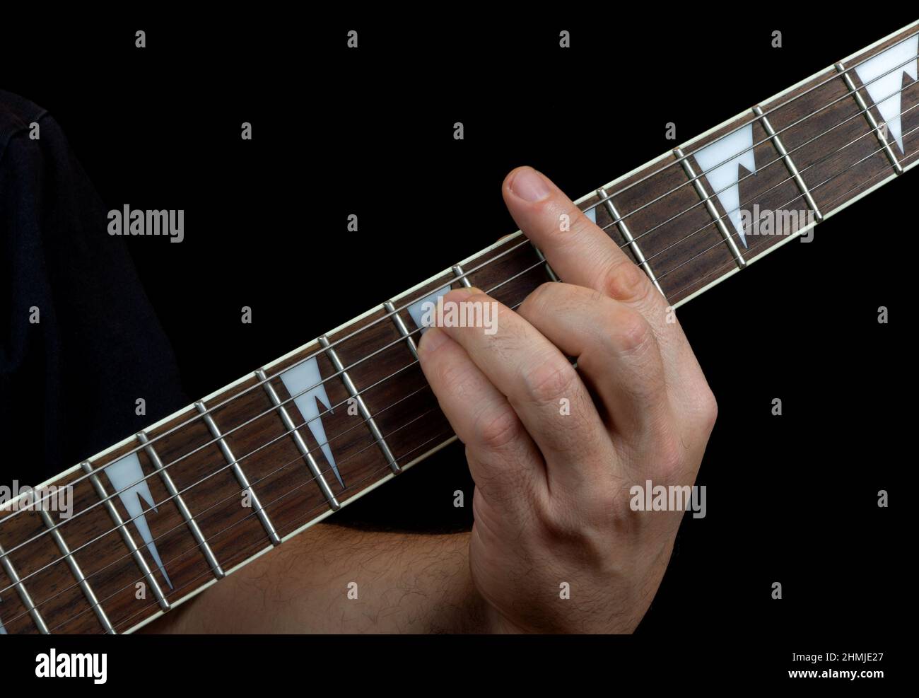 Guitarists hand playing on the fretboard of an electric guitar Stock ...