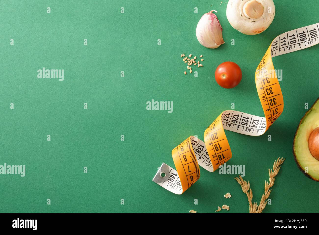 Diet concept background with tape measure and vegetables on green ...