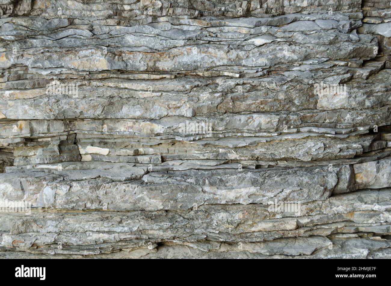 Rock, the background of the layers of ancient sediments.Layered stone ...