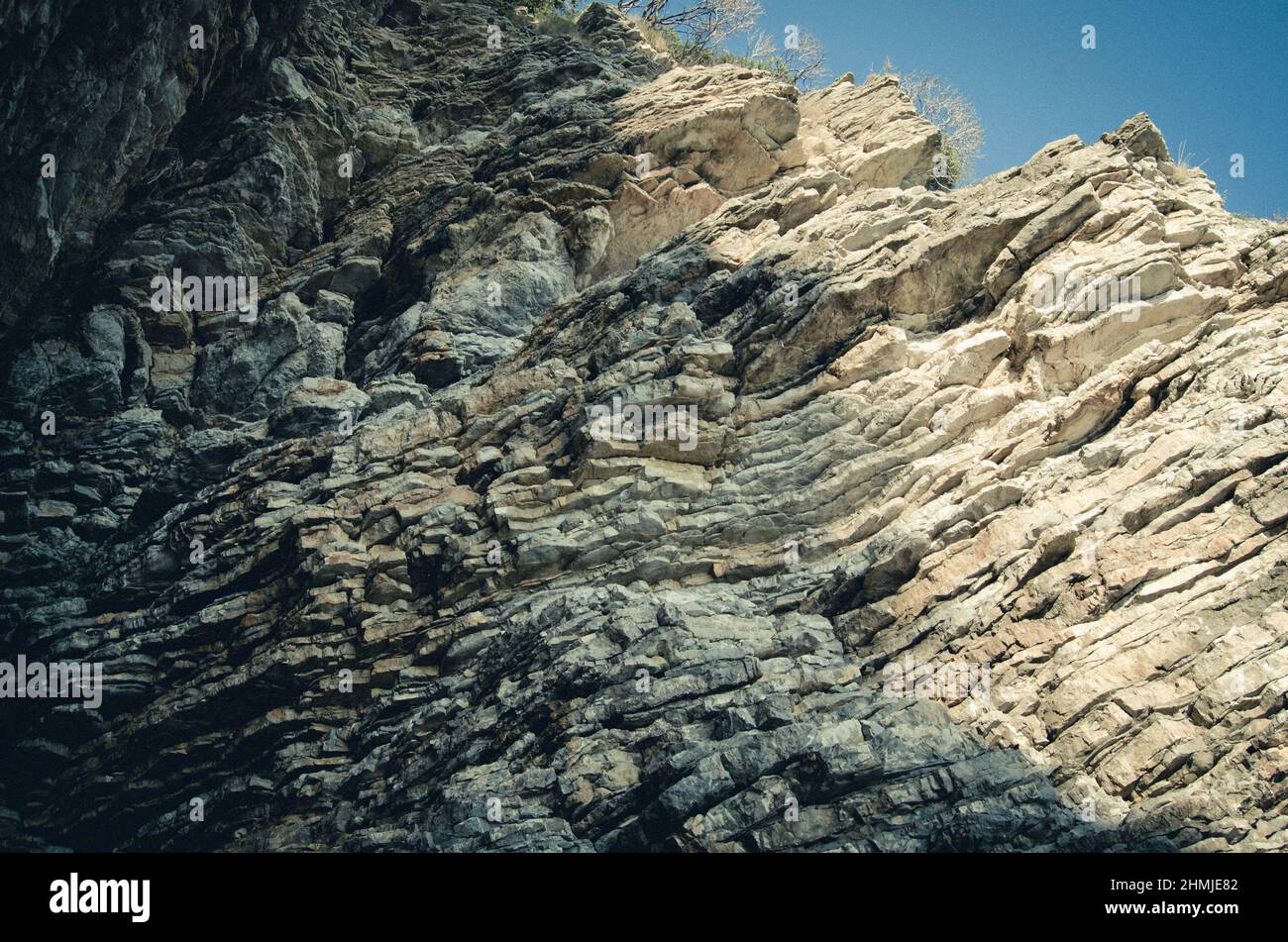 Rock, the background of the layers of ancient sediments.Layered stone ...