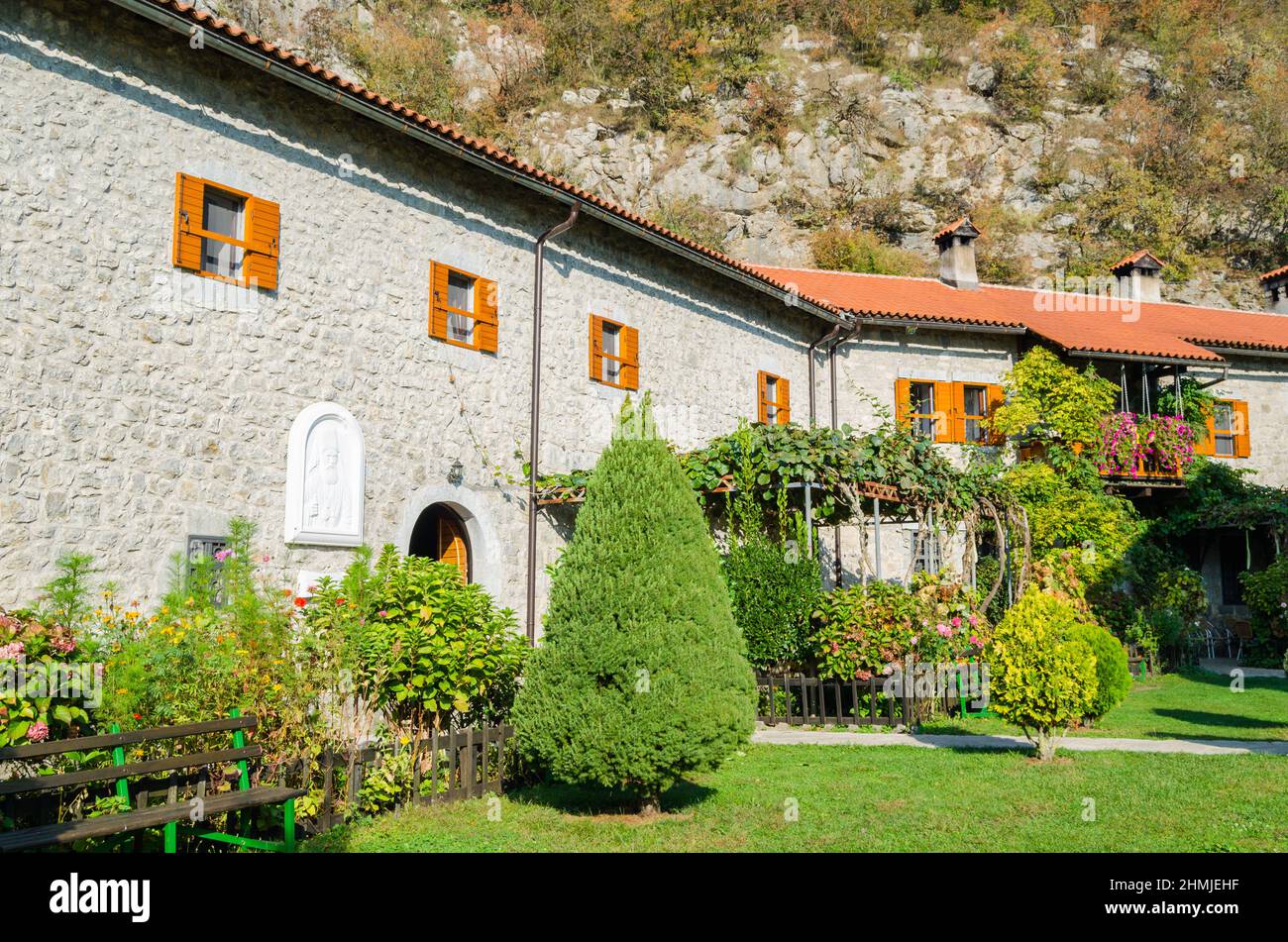 Green landscaped with flowers and trees courtyard in the old monastery ...