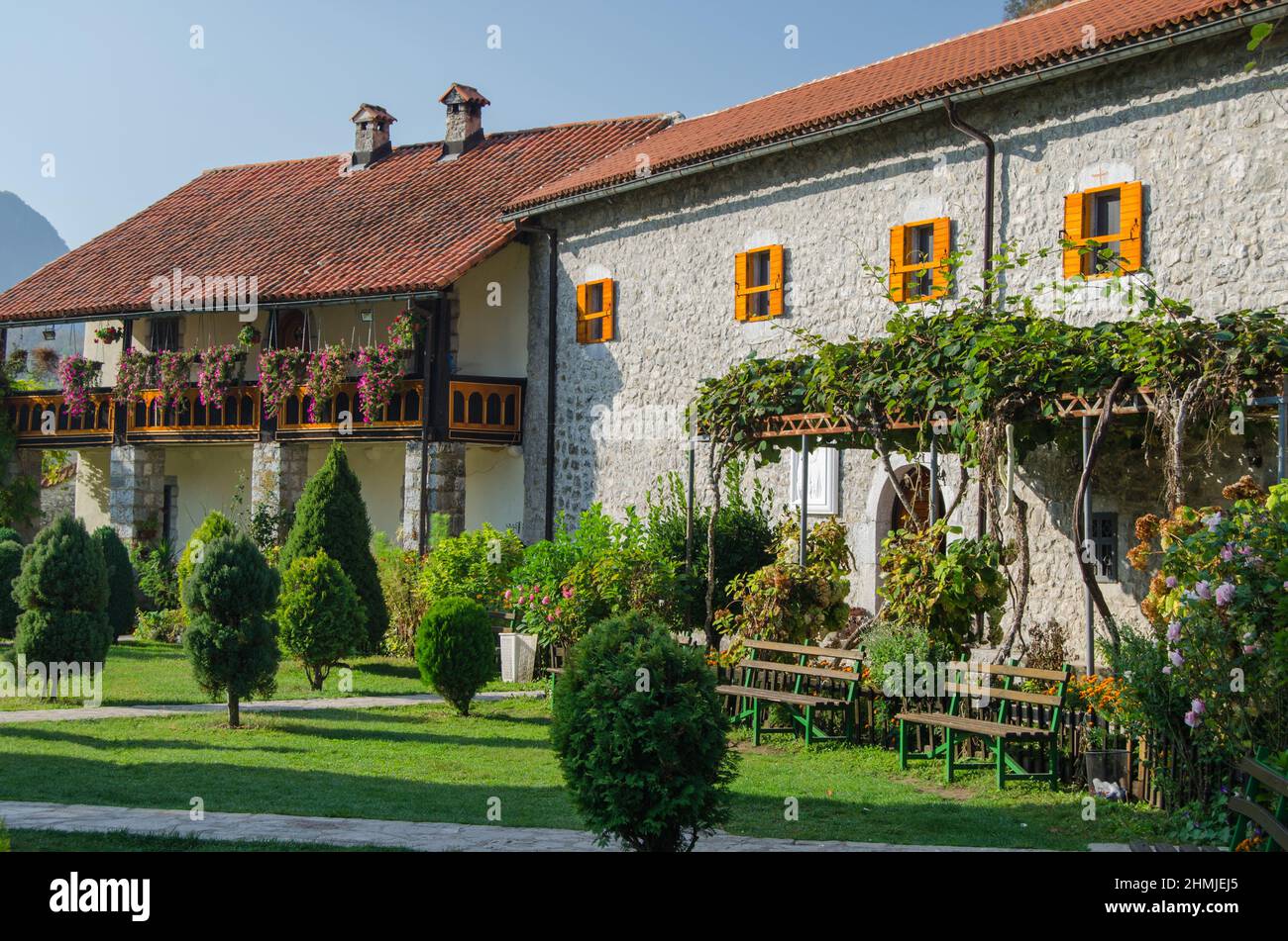 Green landscaped with flowers and trees courtyard in the old monastery ...