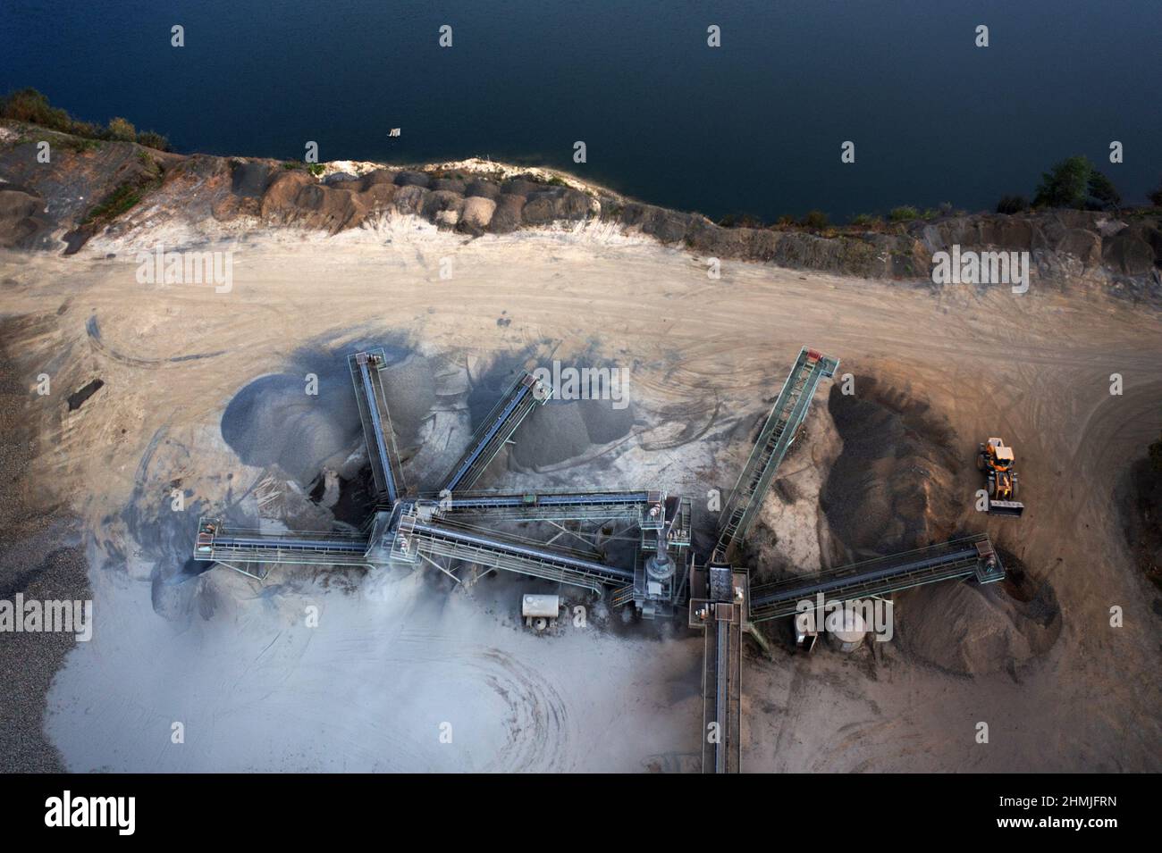 Granite factory. Large piles of granite stones near the lake and ...
