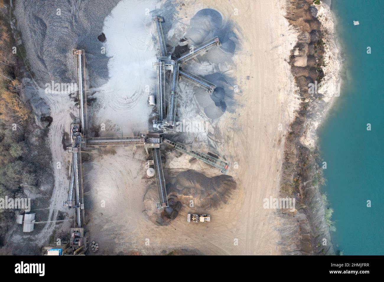 Granite factory. Large piles of granite stones near the lake and ...