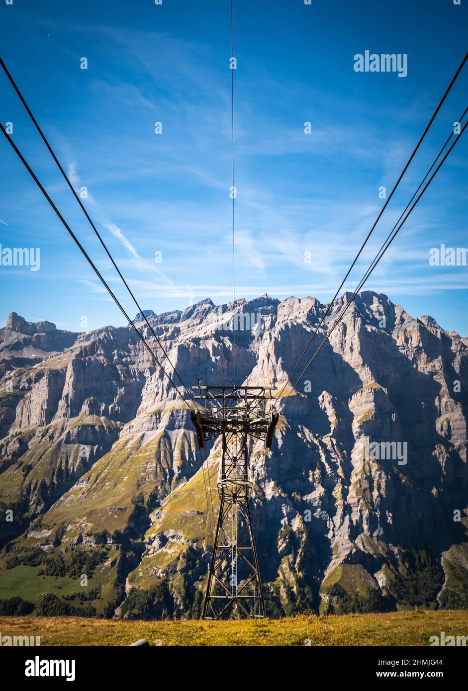 Symmetric view of a cable car mast staning on a mountain, with ...