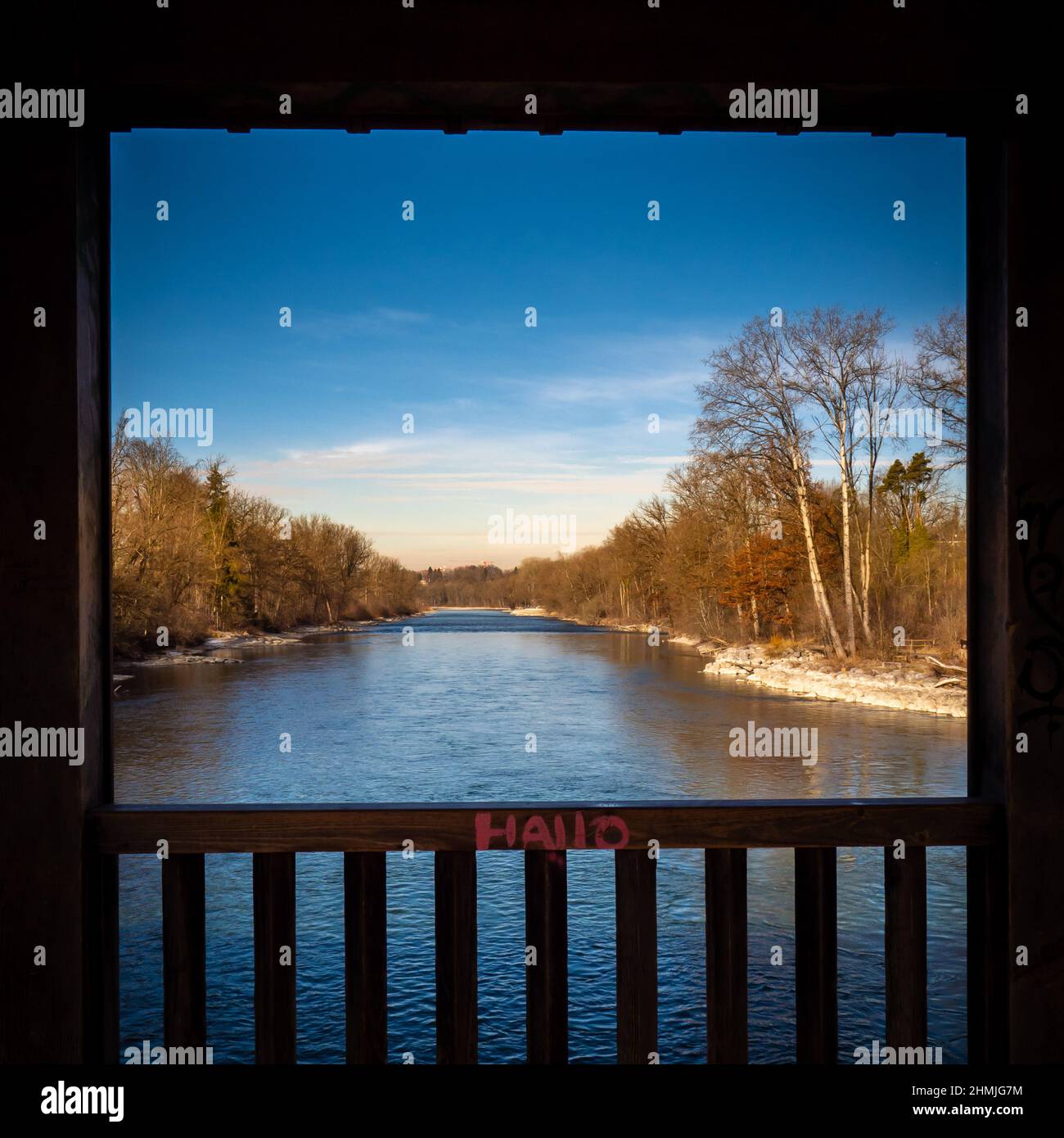 View from a roofed bridge window onto the Aare river, surrounded by ...