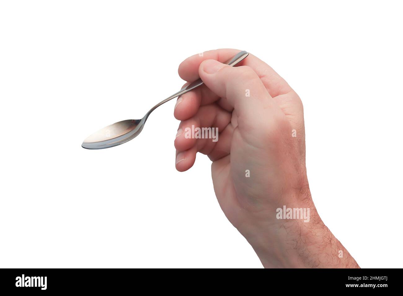 A man's hand with a close-up of a metal teaspoon. Isolate on a white ...