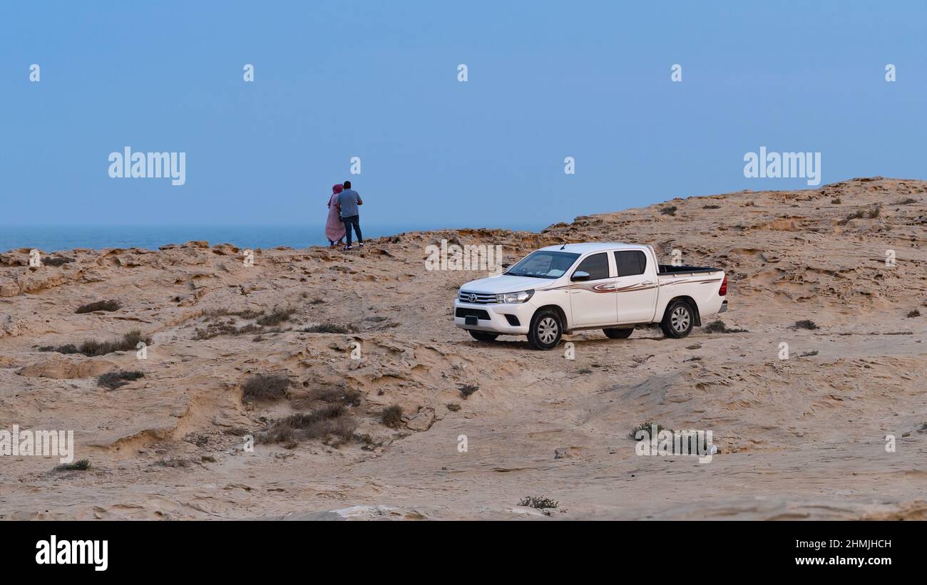 Couple enjoying at Jebel Fuwairit Beach landscape in Qatar Stock Photo ...
