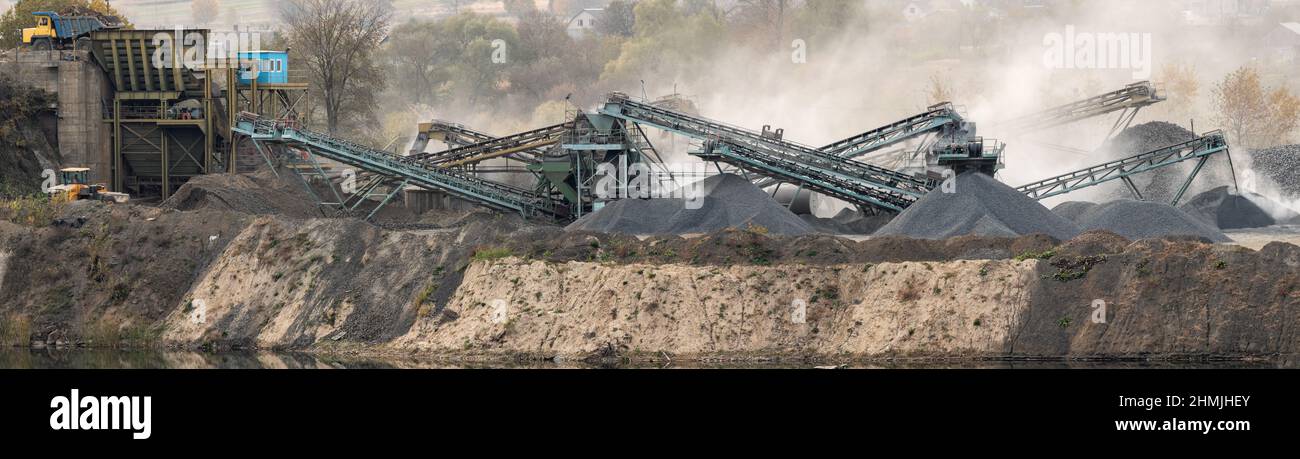 Granite factory. Large piles of granite stones near the lake and ...