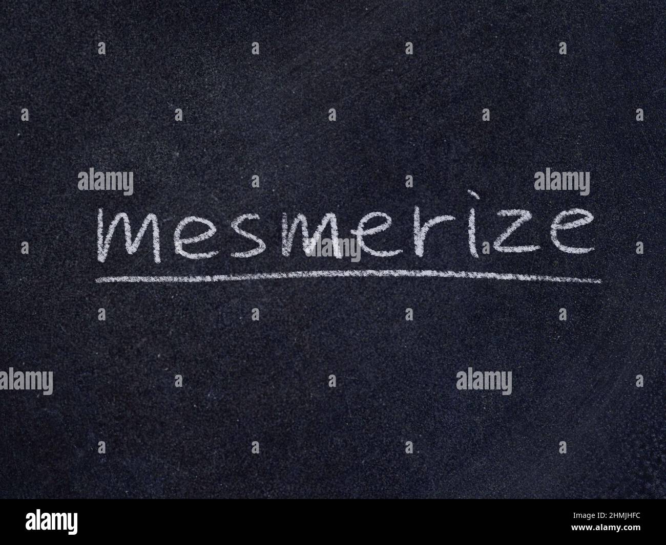 mesmerize concept word on blackboard background Stock Photo - Alamy