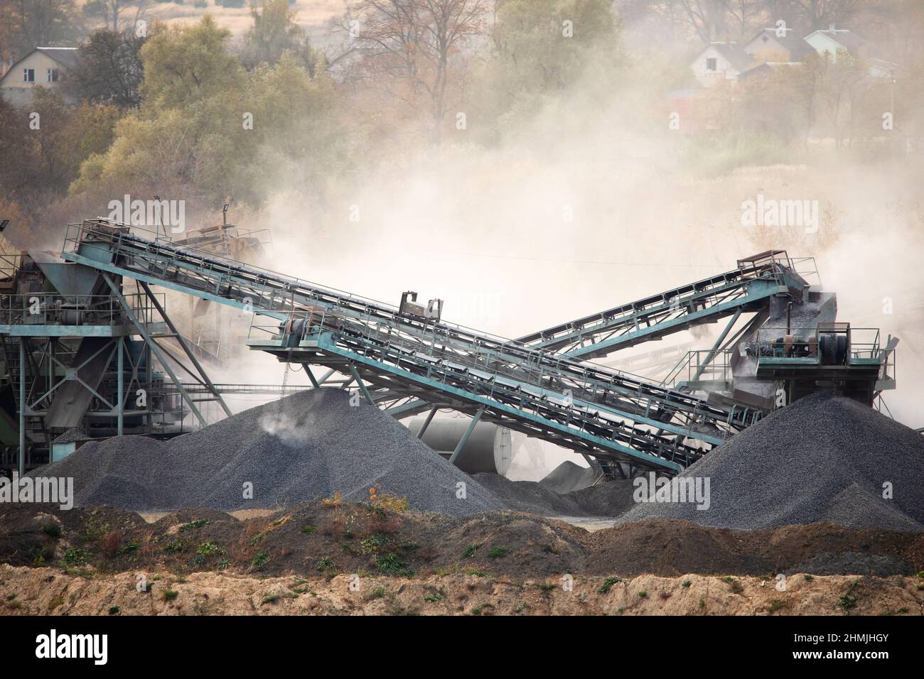 Granite factory. Large piles of granite stones near the lake and ...