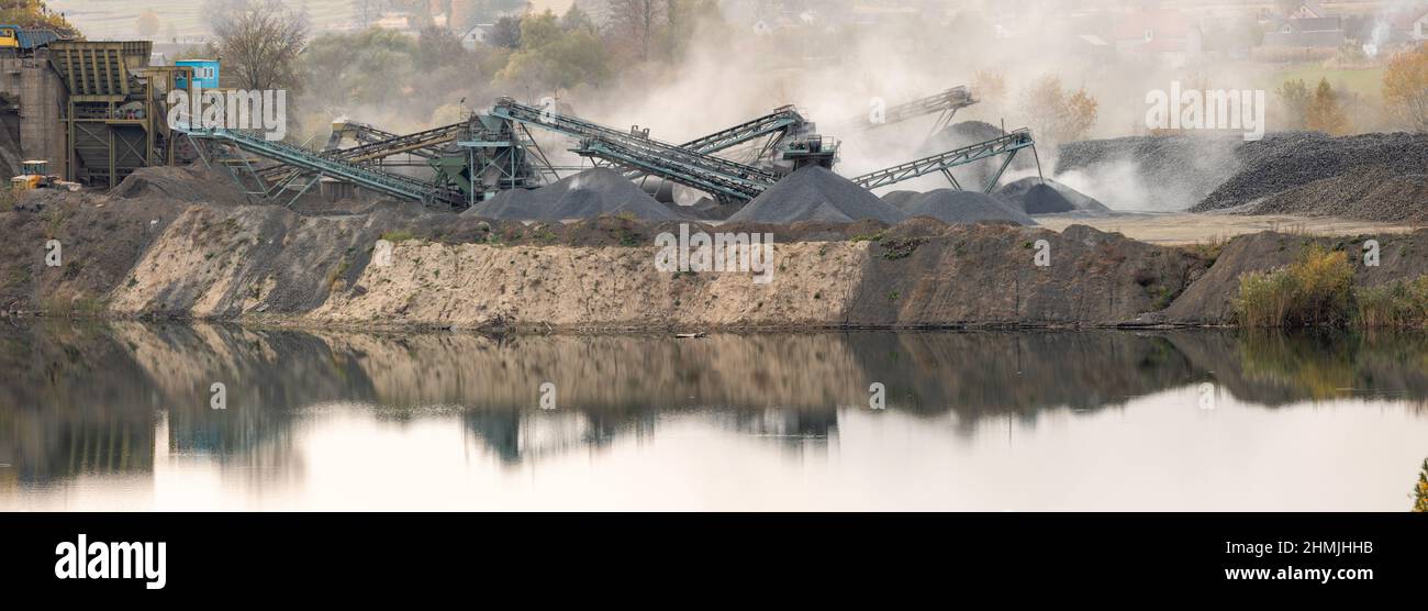 Granite factory. Large piles of granite stones near the lake and ...