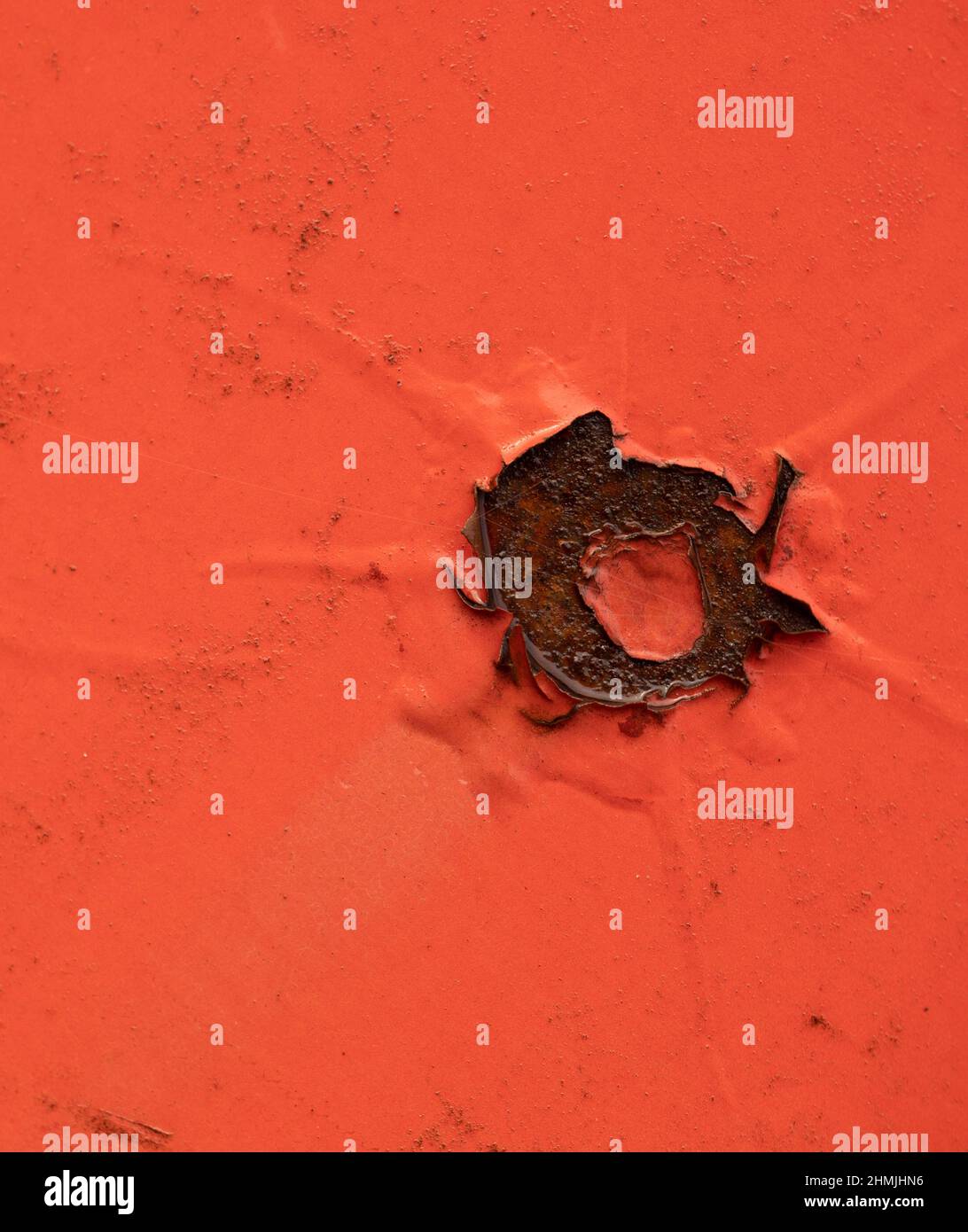 Bullet hole in old metal painted red. Abstract background Stock Photo ...