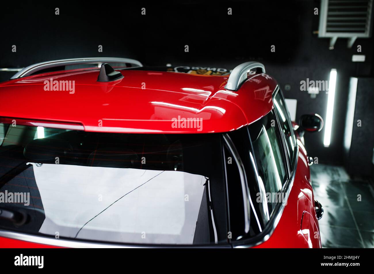 Red polished car in professional detailing garage Stock Photo - Alamy