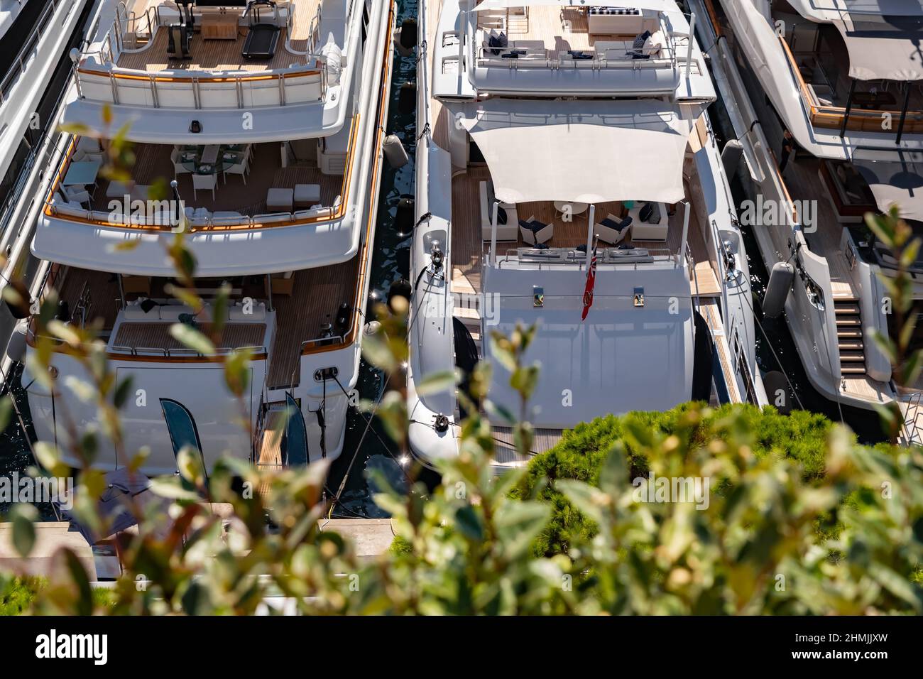 A few of huge moored yachts are in port Hercule of Monaco at sunny day ...