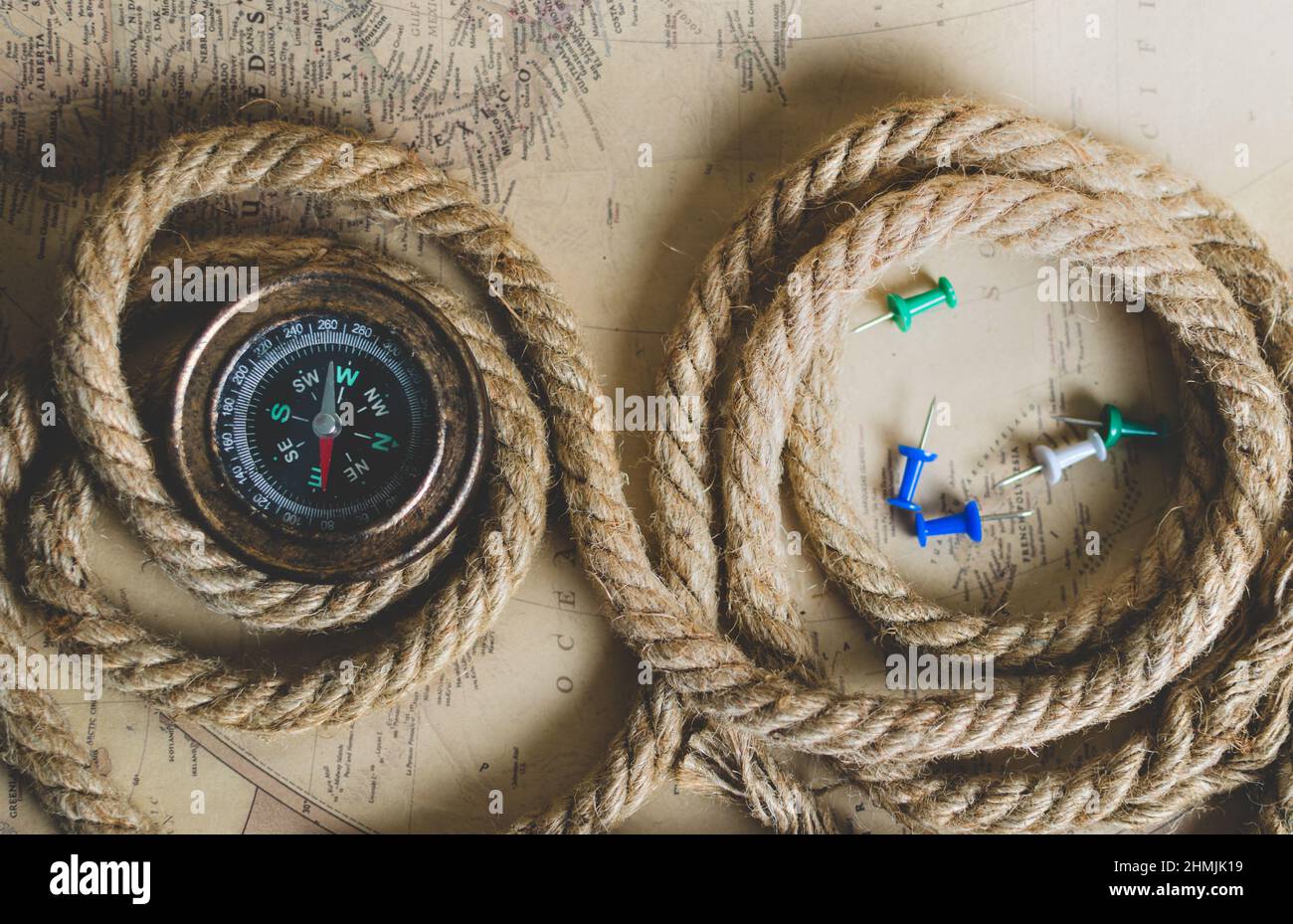 Old compass, rope and buttons on the map in the light of day Stock ...