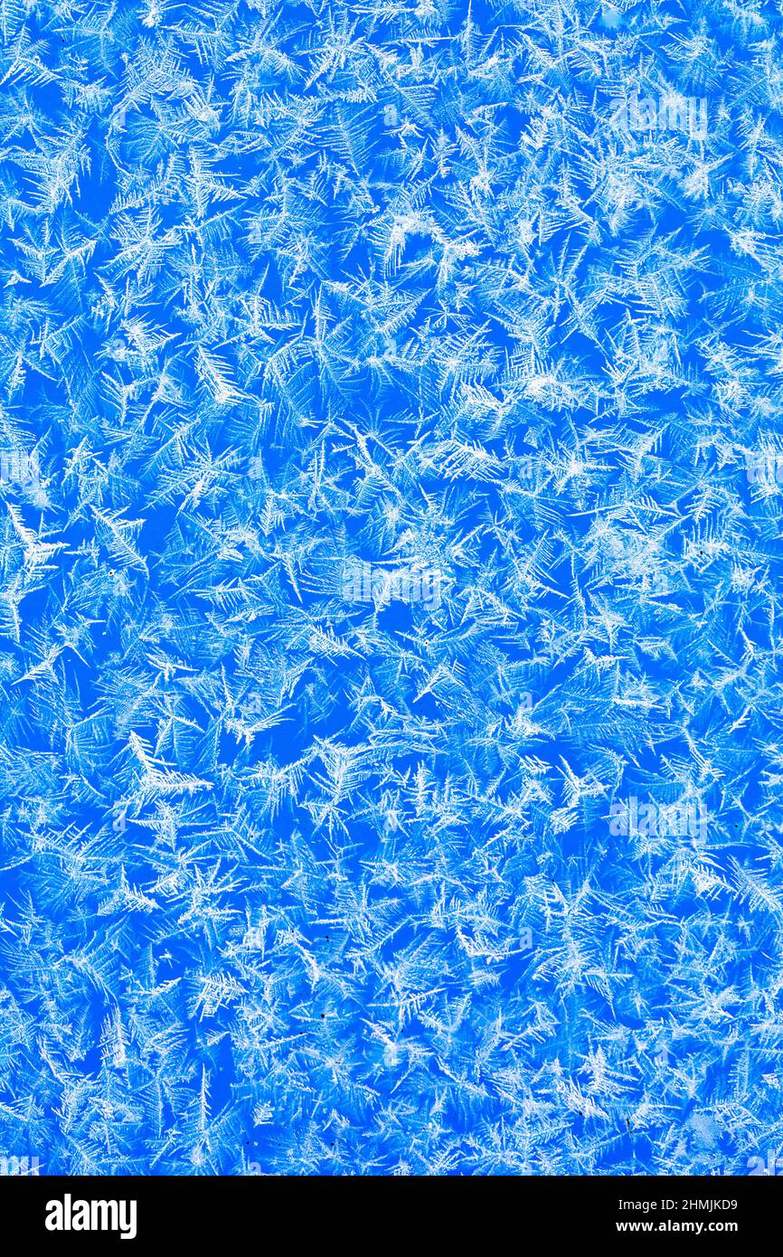 Frost on the glass. Patterns of ice crystals. Natural abstract ...