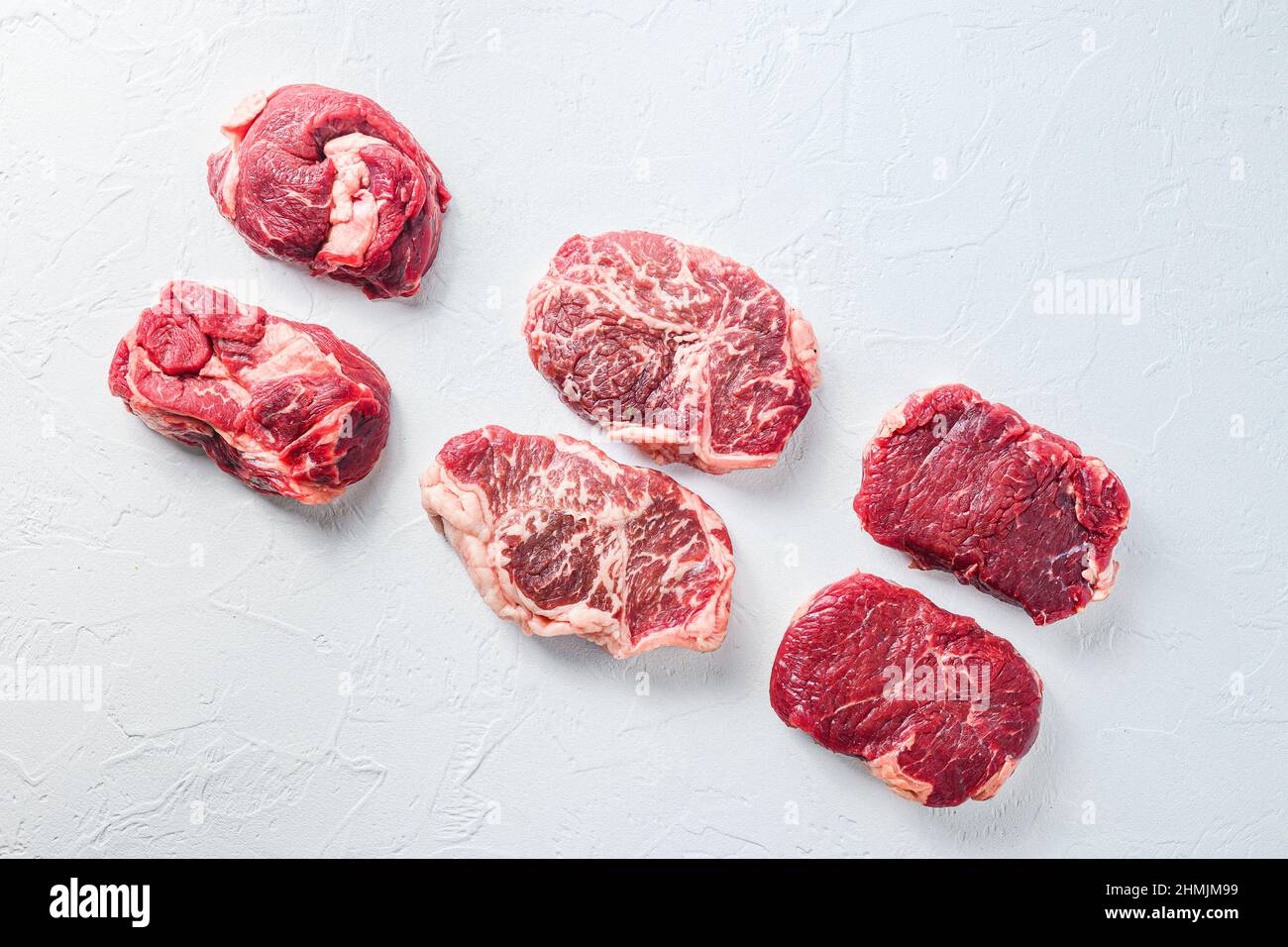 Raw set of alternative beef cuts Chuck eye roll, top blade, rump steak ...