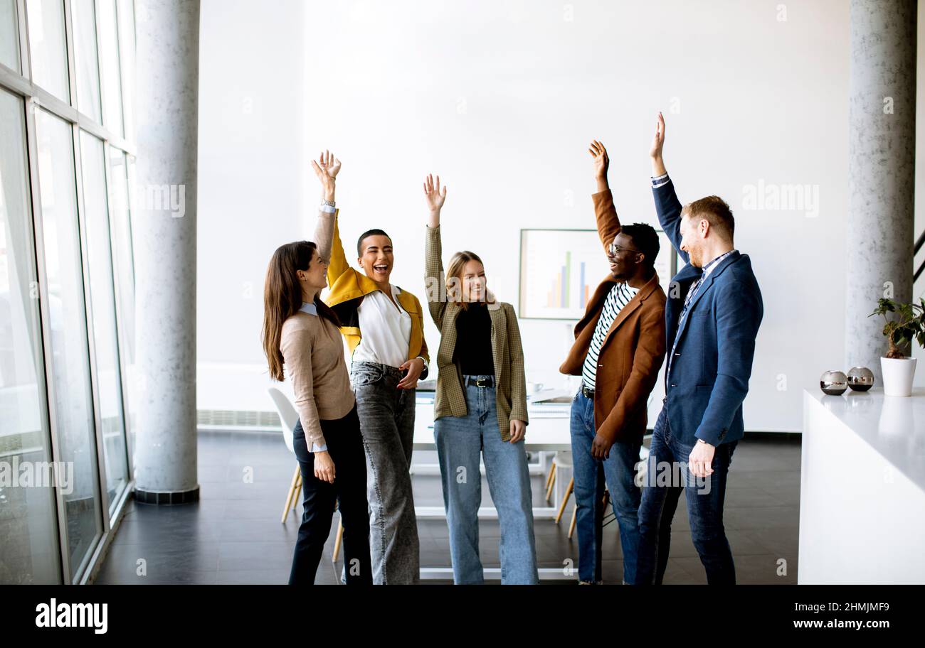 Creative team putting their hands together in the modern office Stock ...