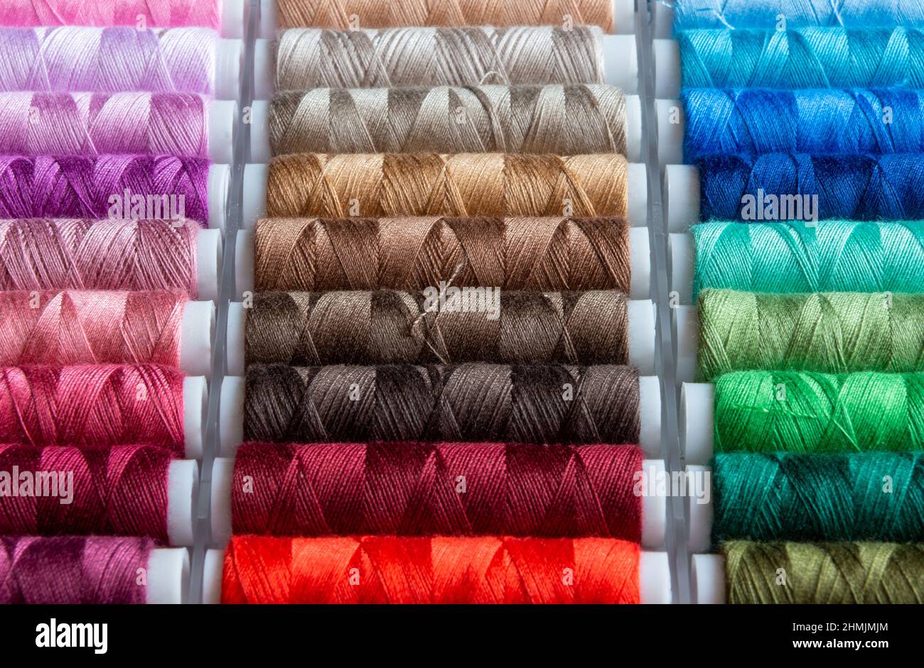 Sewing thread rolls in different colors Stock Photo - Alamy