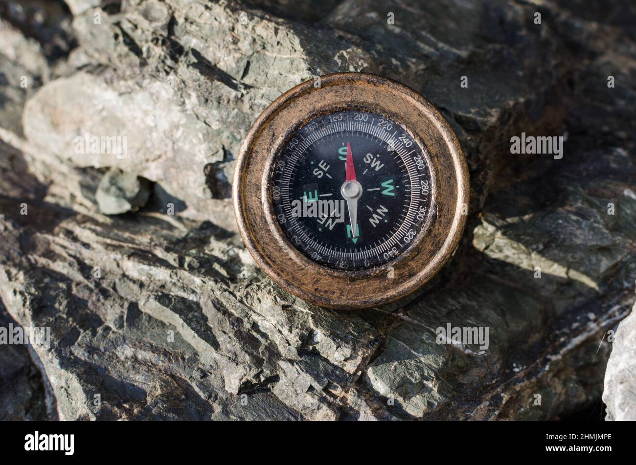 Compass on granite stone.Tool for direction on road and travel,close up ...