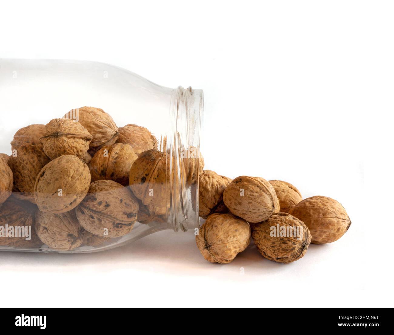 Whole solid walnuts in a jar on white background Stock Photo - Alamy