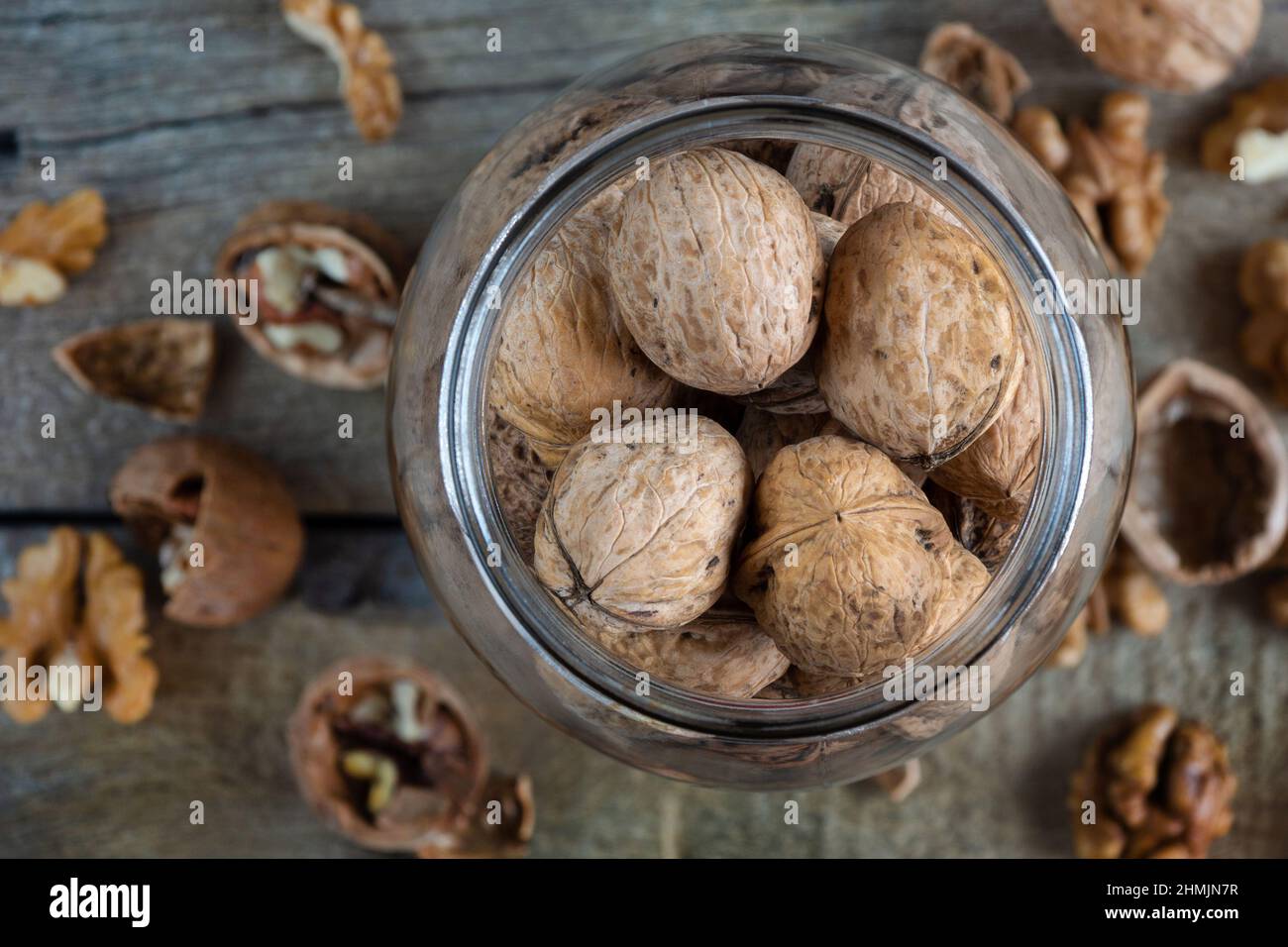 Whole solid walnuts in a jar top view Stock Photo - Alamy