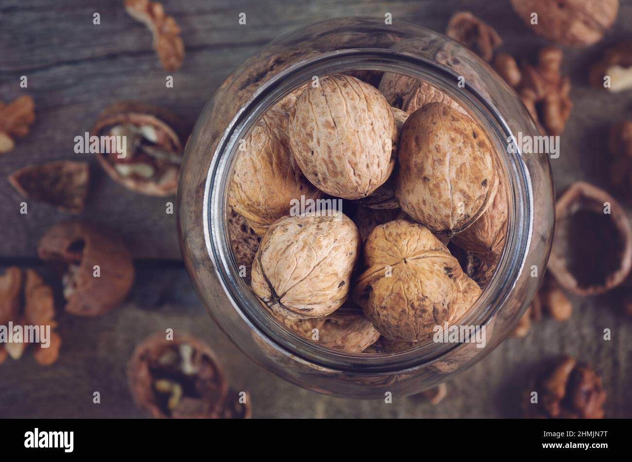 Whole solid walnuts in a jar top view Stock Photo - Alamy