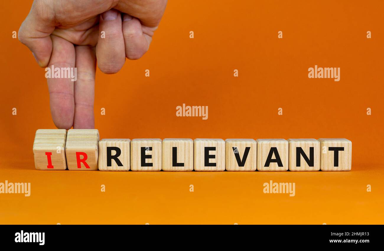 Relevant or irrelevant symbol. Businessman turns wooden cubes changes ...