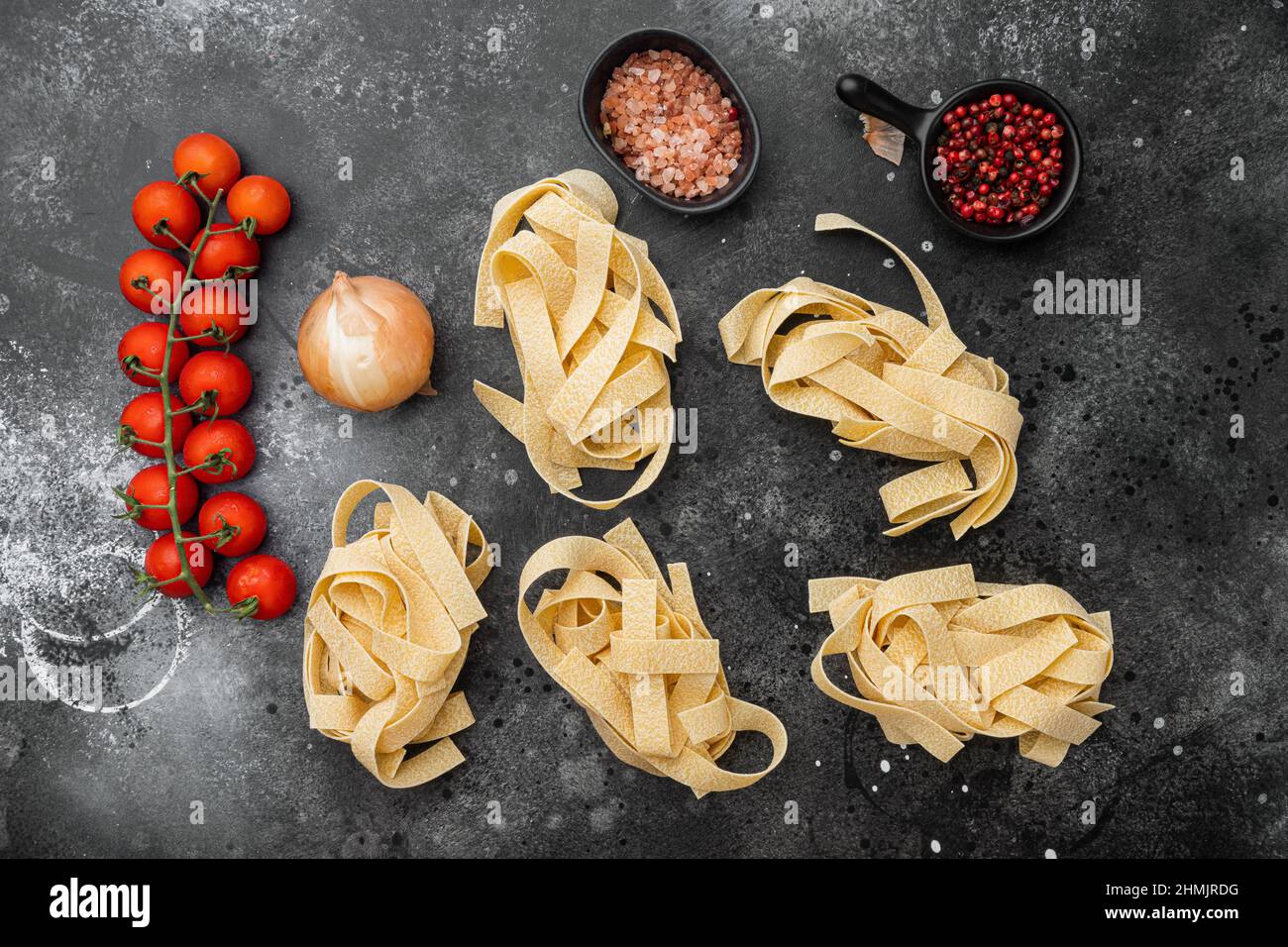 Raw pasta ingredient set, on black dark stone table background, top ...