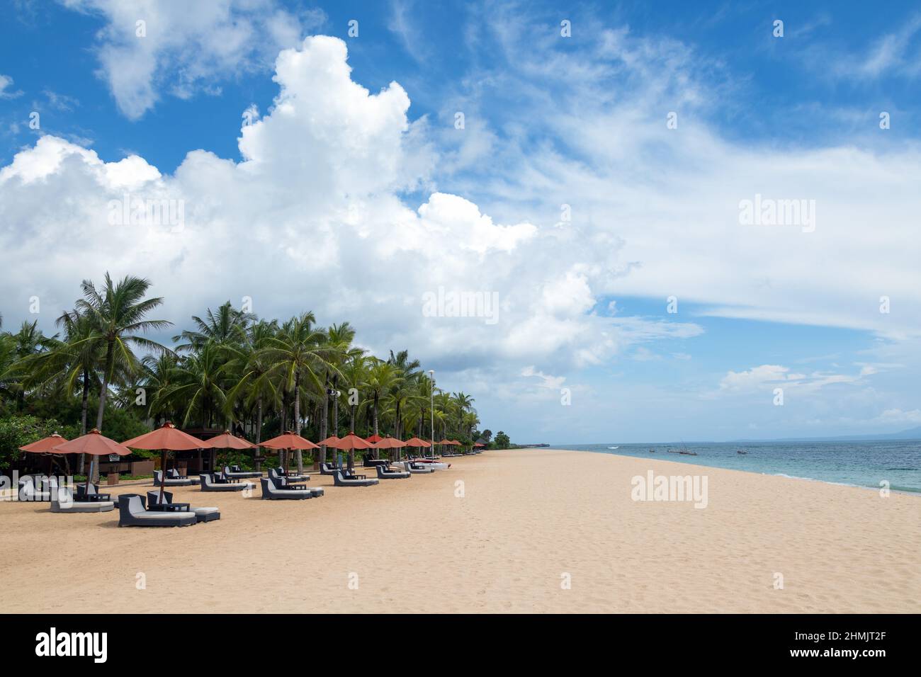 Empty beach with umbrellas and deck chairs. Palm trees. Beautiful ...