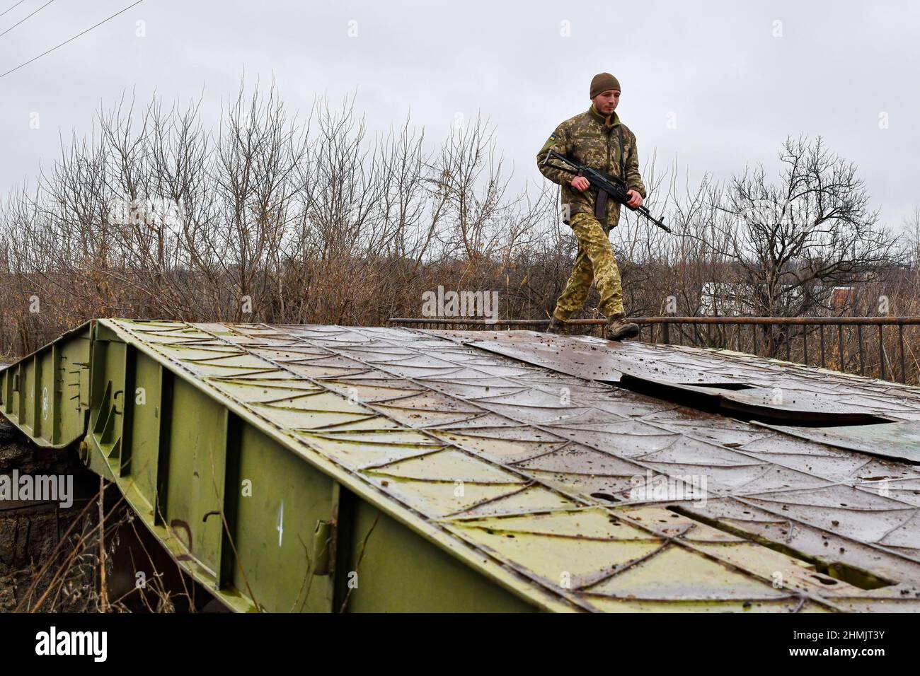 A Ukrainian serviceman is seen walking on the military pontoon bridge ...