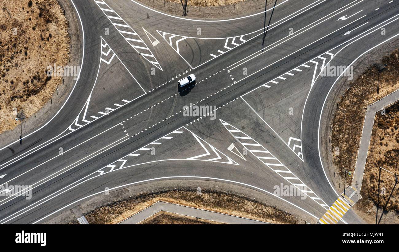A crossroads and a passenger car in the middle of the desert outside ...