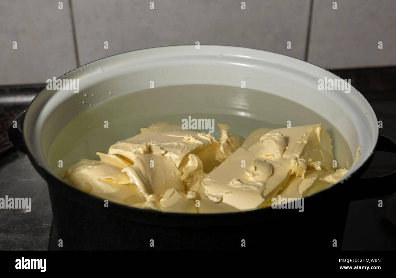 Cooking of yellow and green marijuana medicinal butter in hot water in ...