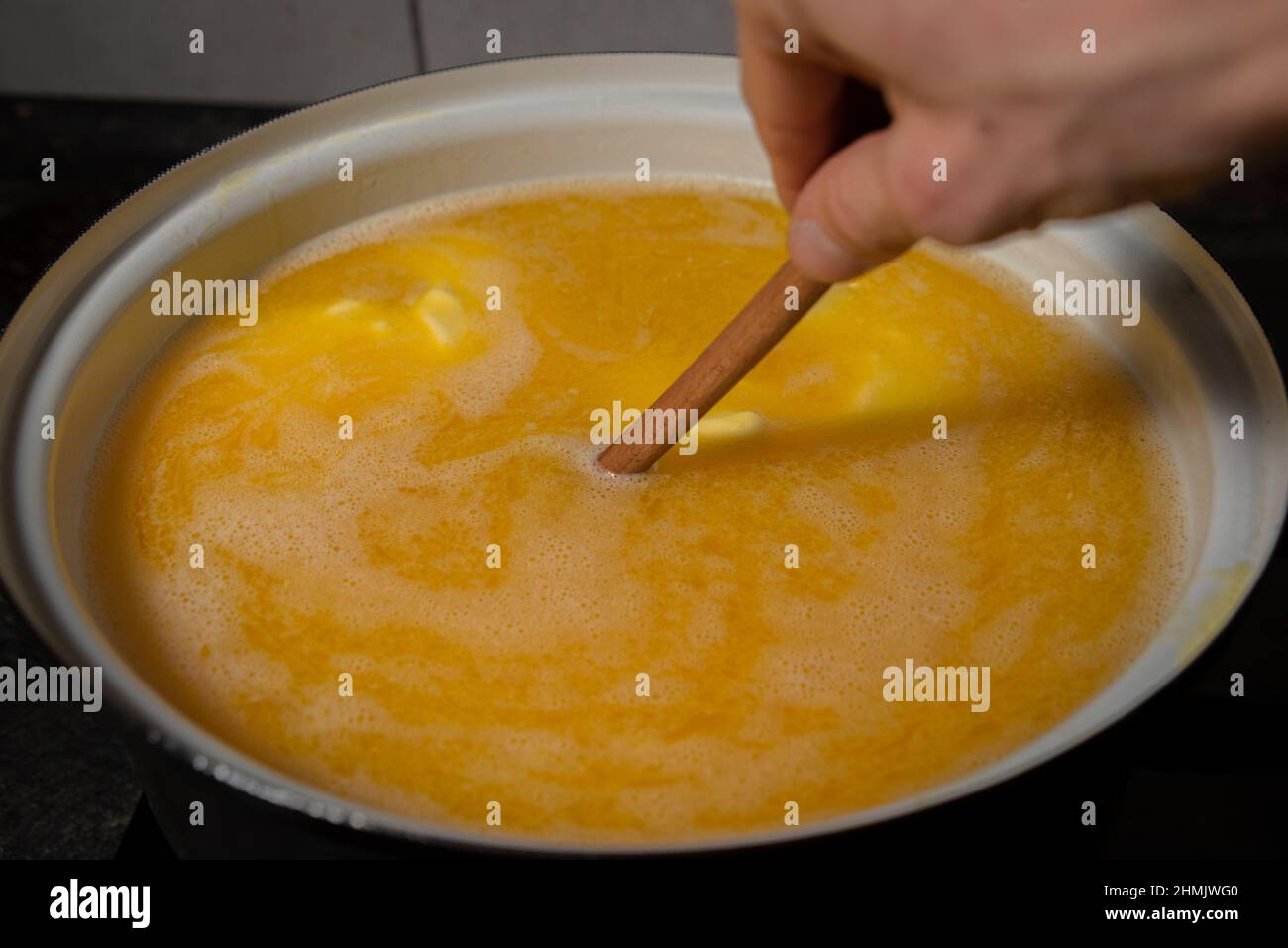 Cooking of yellow and green marijuana medicinal butter in hot water in ...