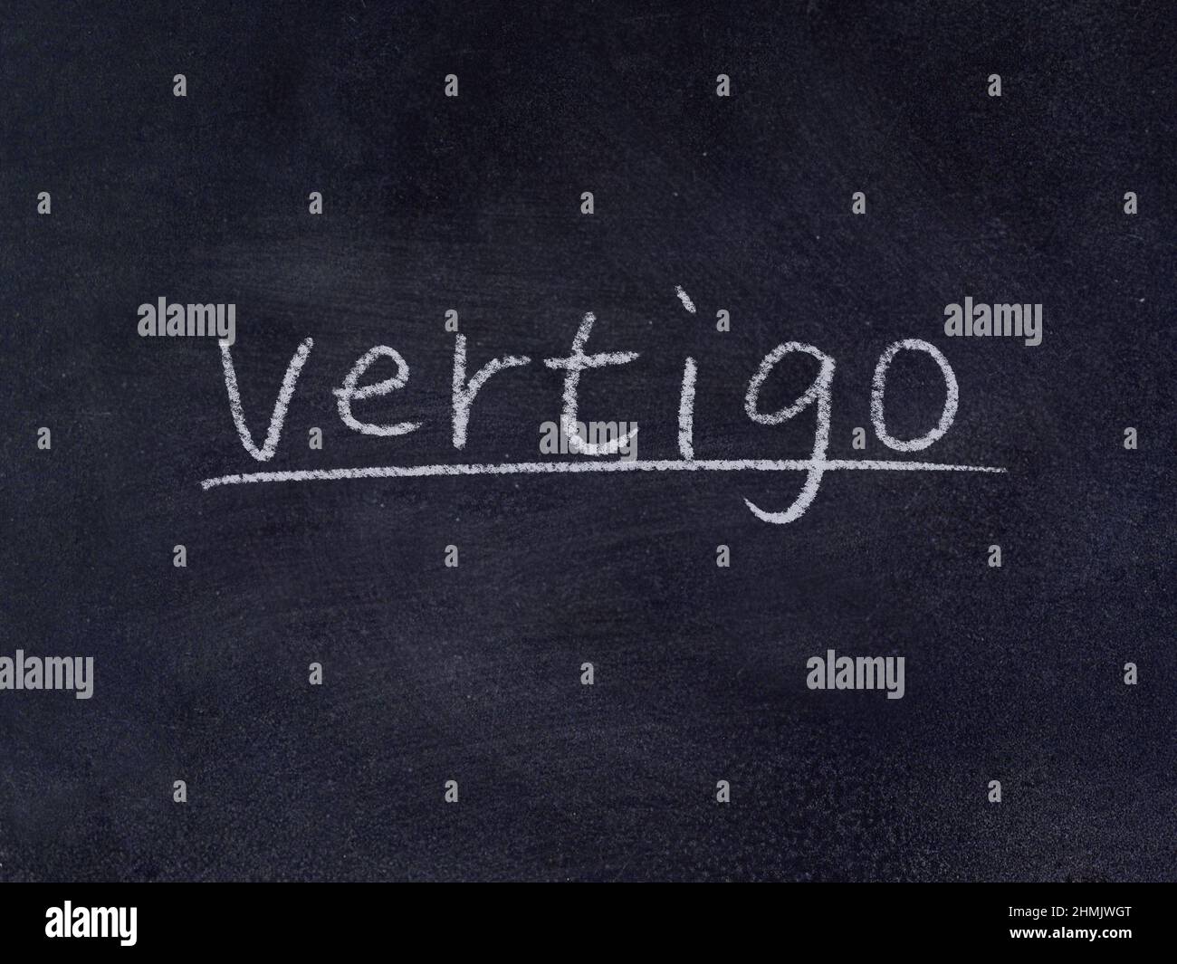 vertigo concept word on blackboard background Stock Photo - Alamy
