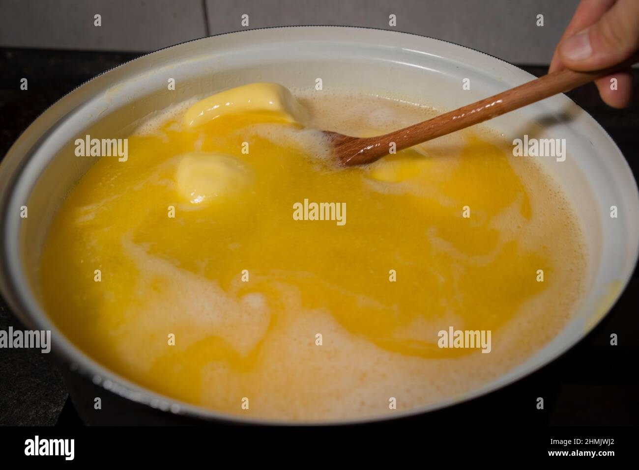 Cooking of yellow and green marijuana medicinal butter in hot water in ...