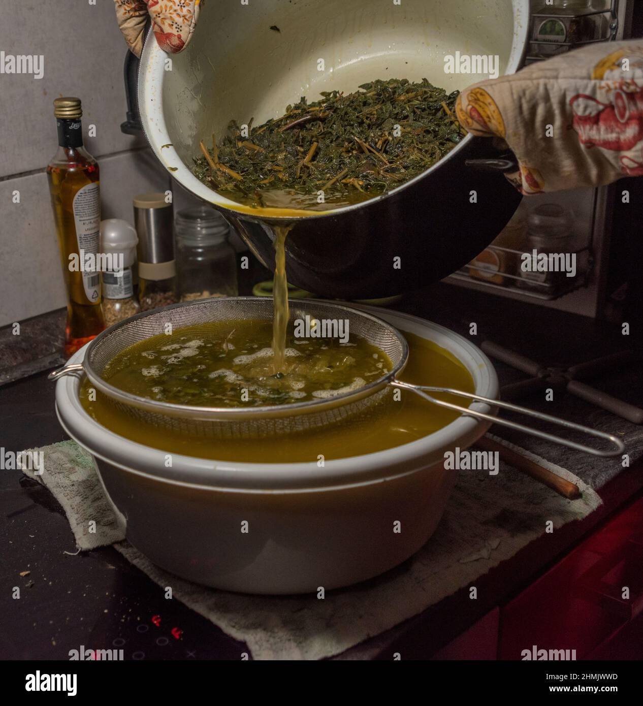 Cooking of yellow and green marijuana medicinal butter in hot water in ...
