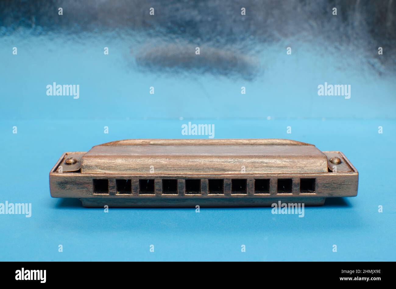 Old harmonica on a blue background.Musical instrument Stock Photo - Alamy