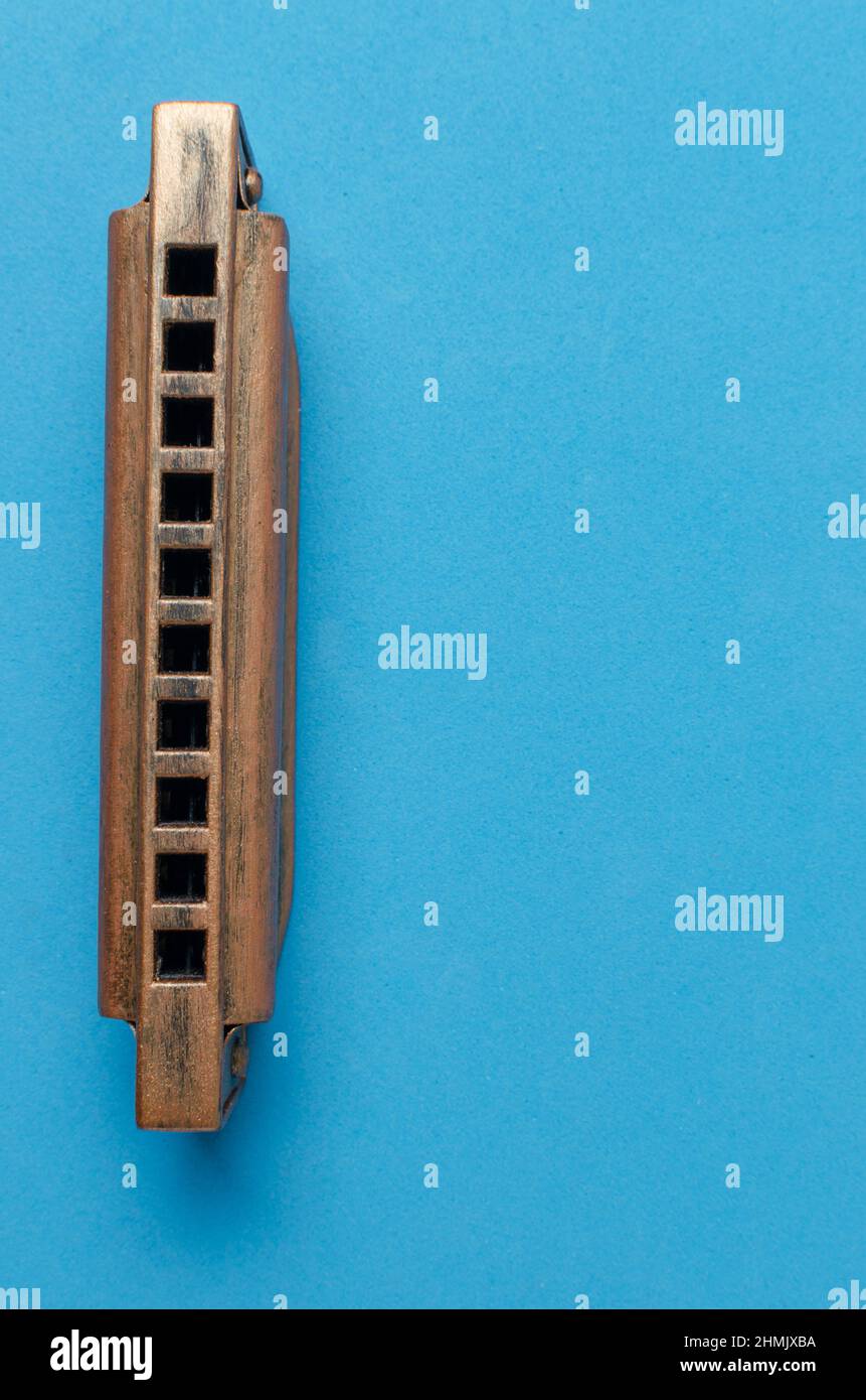 Old harmonica on a blue background.Musical instrument Stock Photo - Alamy