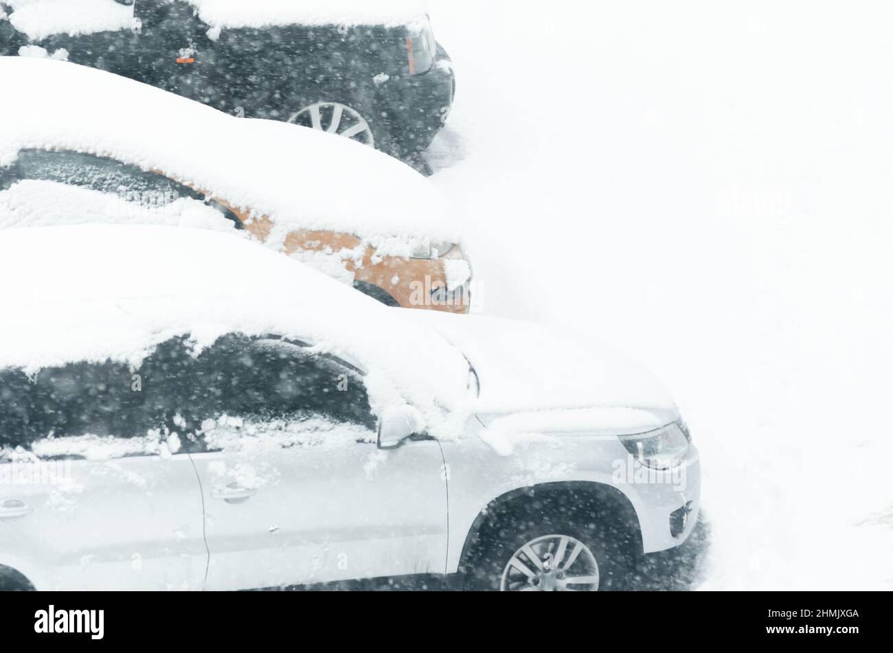 Cars were covered with a thick layer of snow during heavy snowfall ...